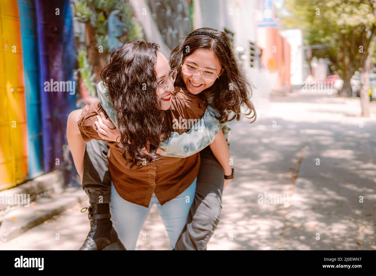 Happy friend playing and lifting up her little friend Stock Photo - Alamy