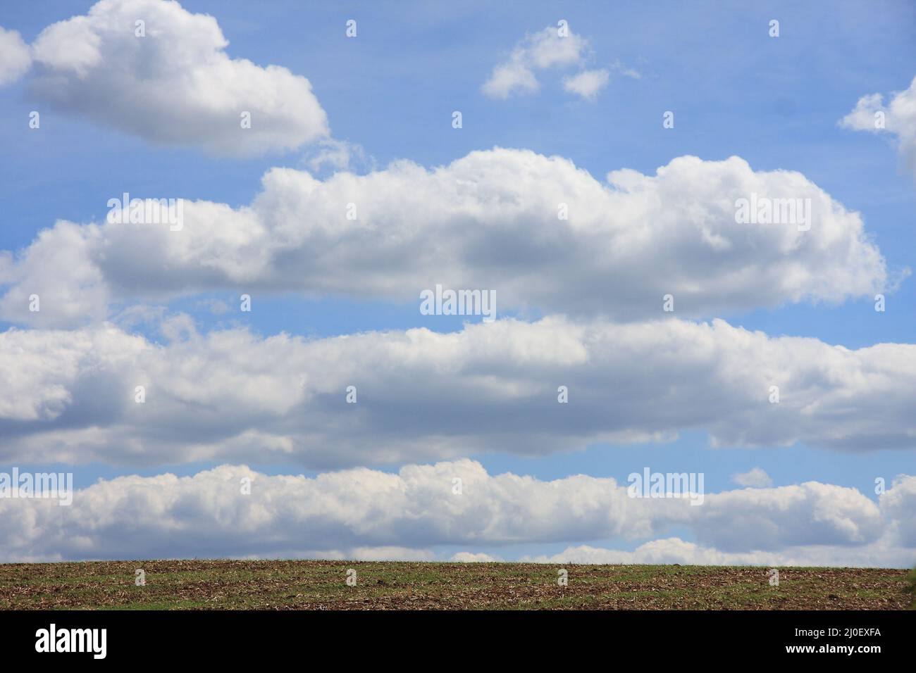 Blue sky clouds above sea hi-res stock photography and images - Alamy