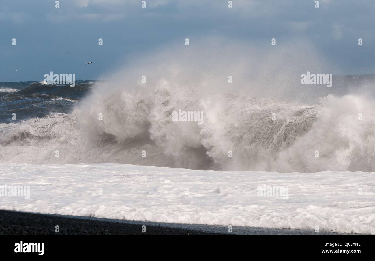 Dangerous waves splashing to the shore during a windstorm Stock Photo ...