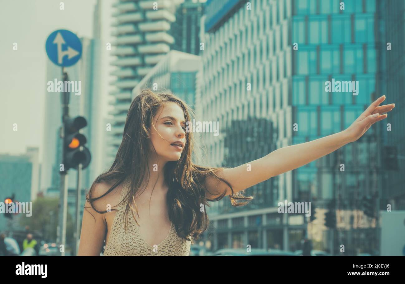 Get a ride. Woman hailing taxi. Woman catch taxicar on city street ...