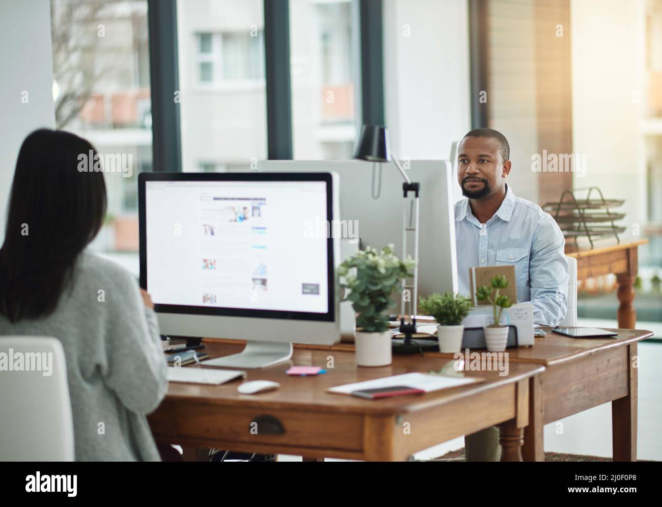 Working on their own parts of the project. Cropped shot of two ...