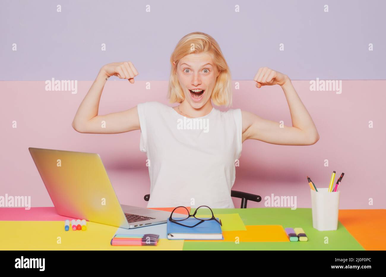 Female crazy fun student shows muscles, woman power. Young teacher or ...