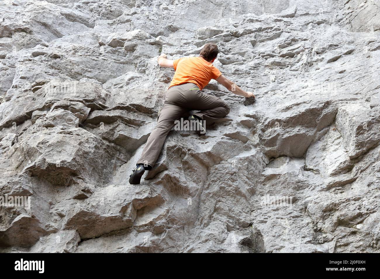 Climbing on a rock wall Stock Photo - Alamy