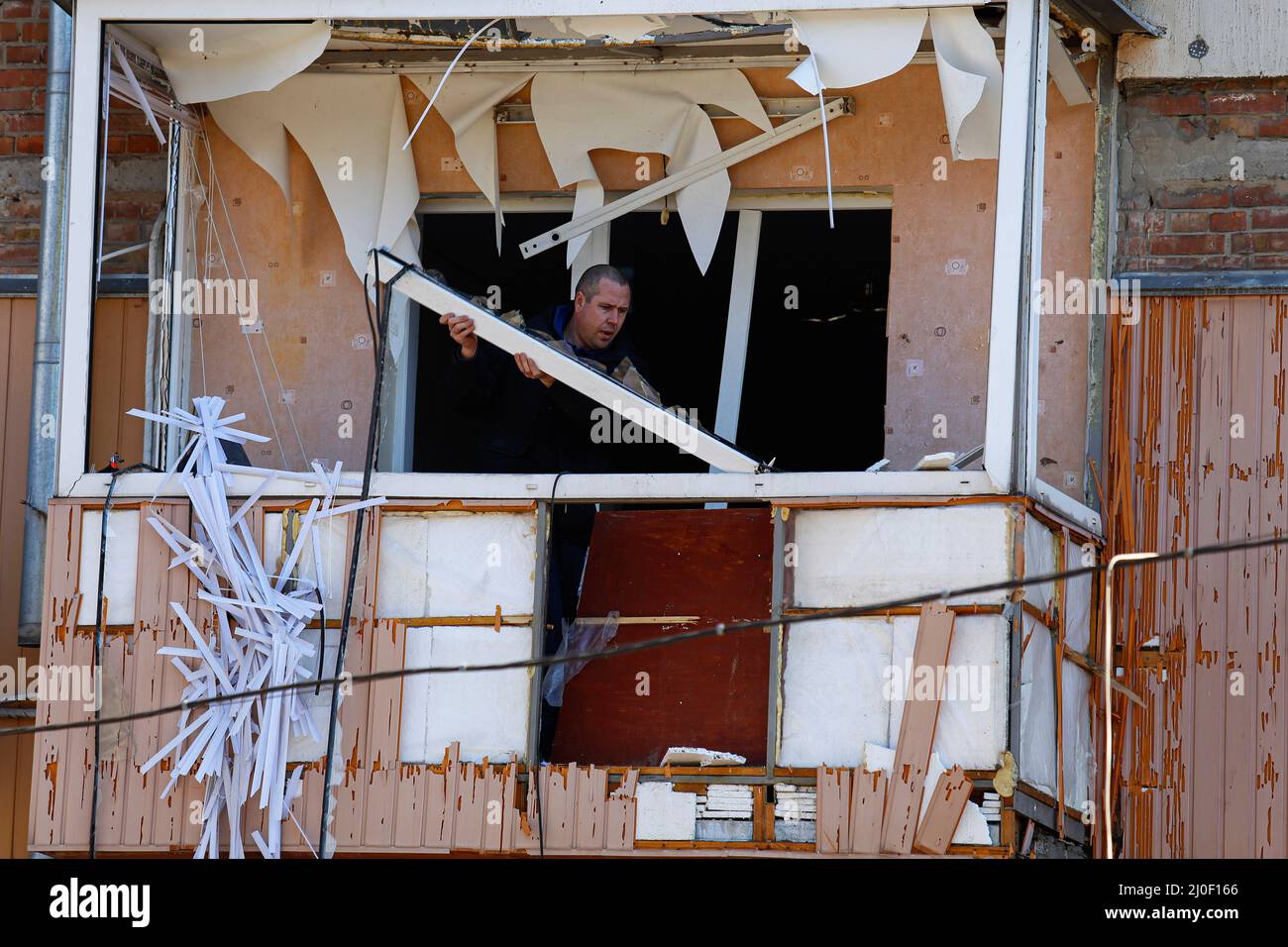 Kyiv, Ukraine. 18th Mar, 2022. A man seen on the balcony of a destroyed ...