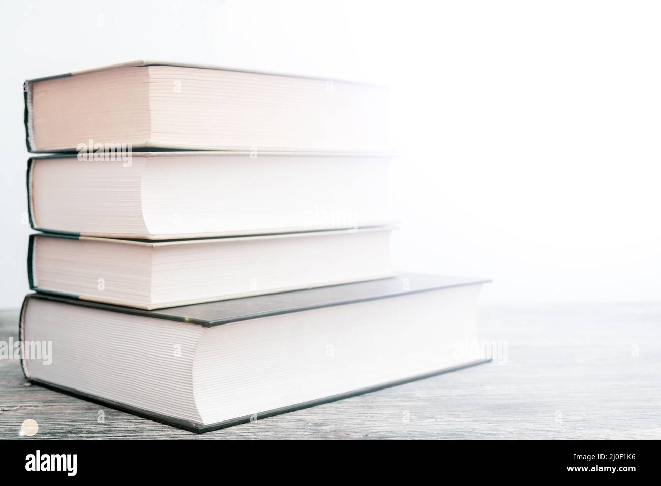 Thick paper books are a symbol of education and wisdom. A stack of ...