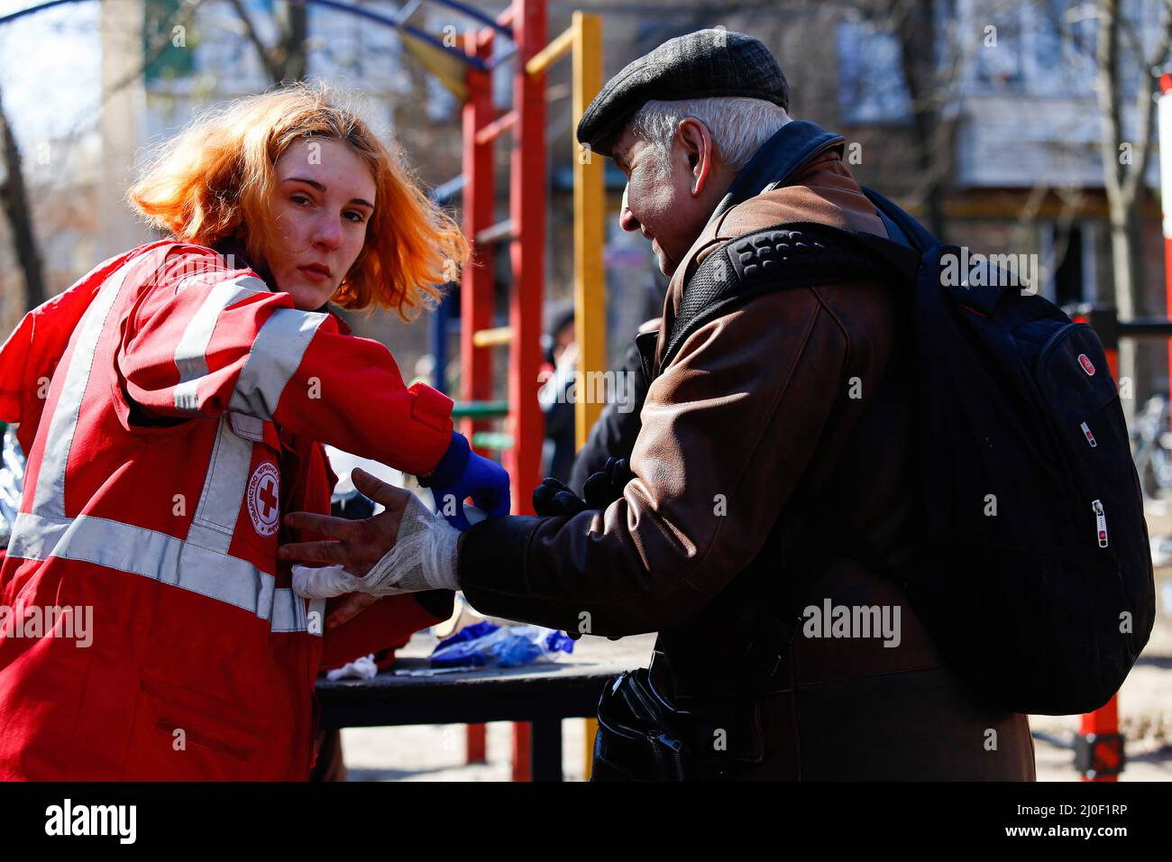 Kyiv, Ukraine. 18th Mar, 2022. An emergency lady seen bandaging an old ...