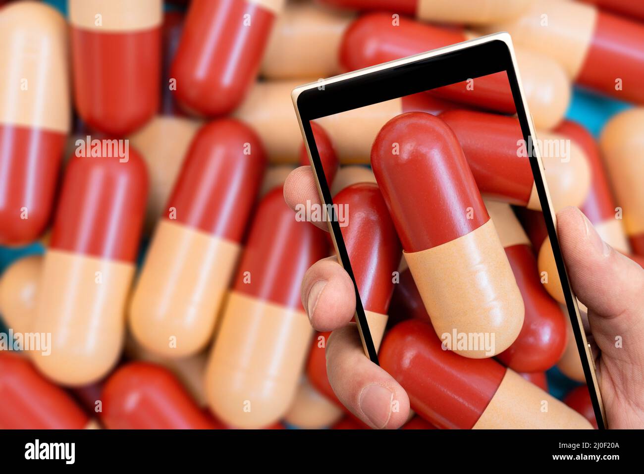 Medication capsules on smartphone screen. Pharmaceutical drug is ...