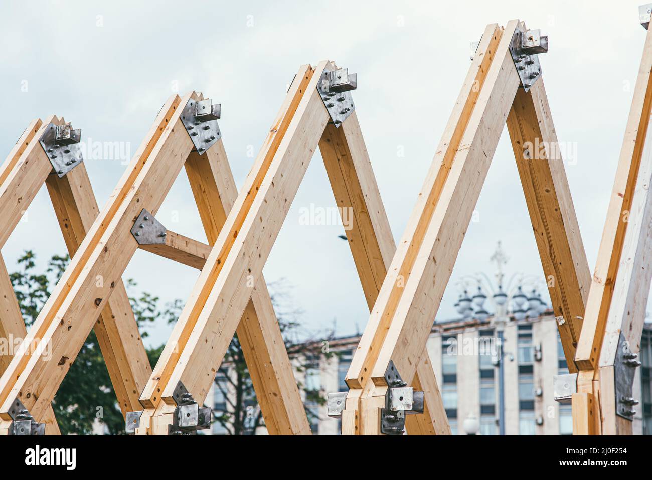 Wooden rafters of unfinished roof against the background of the city ...