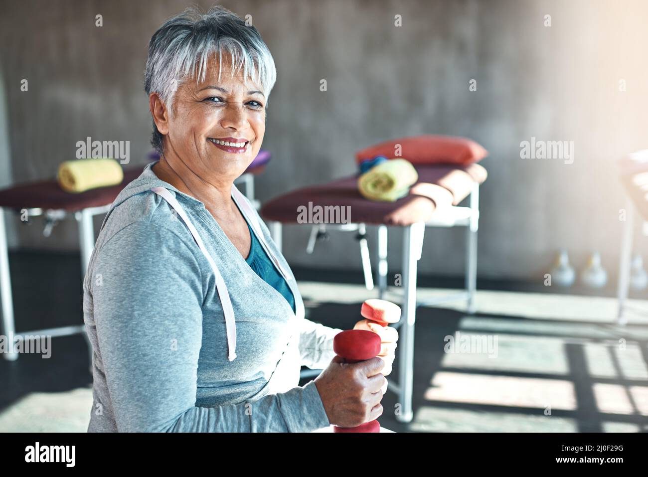 Forever fit, thats my motto. Portrait of a happy senior woman working ...