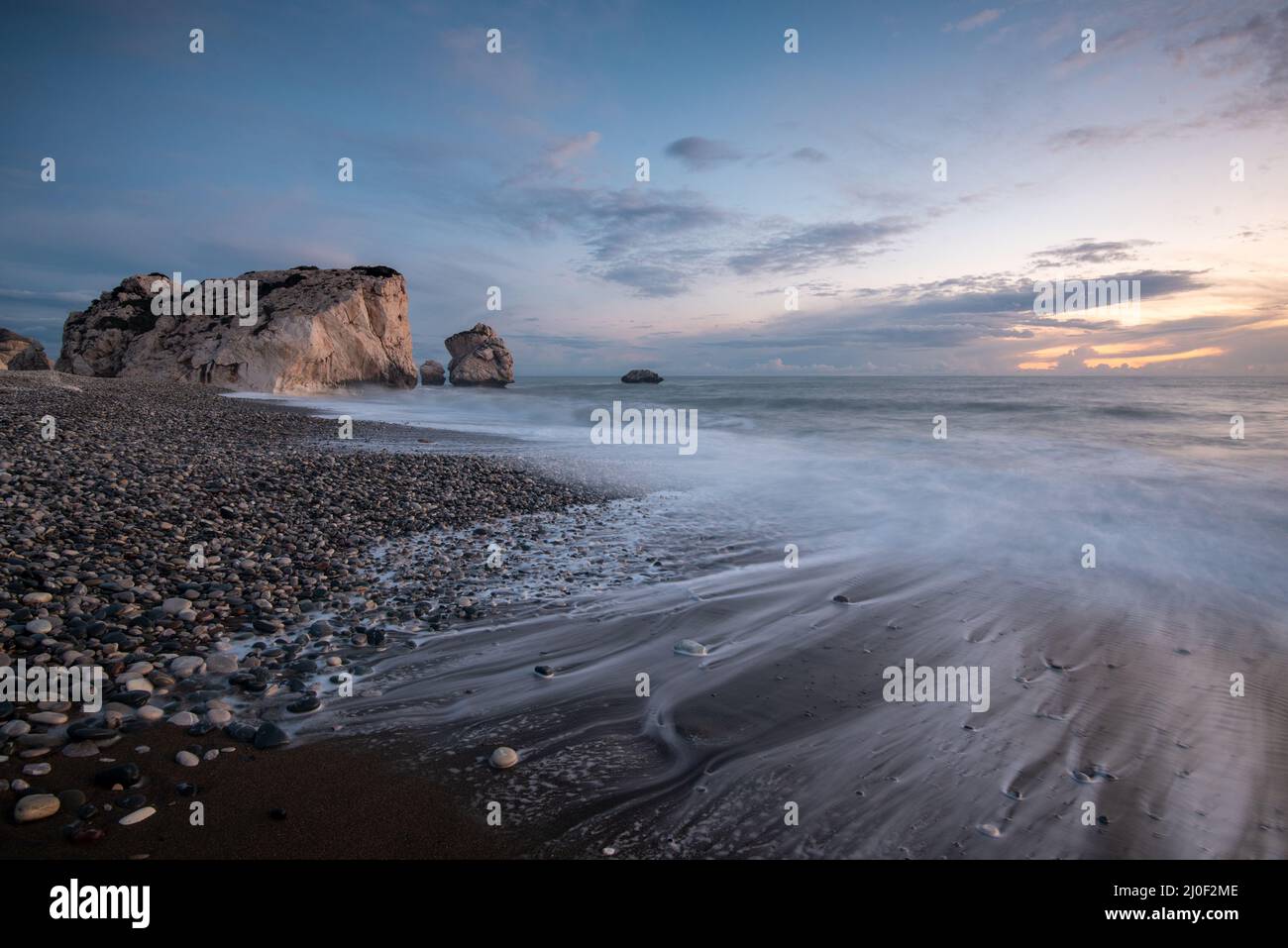 Seascape with windy waves and moody sky during sunset. Rock of ...