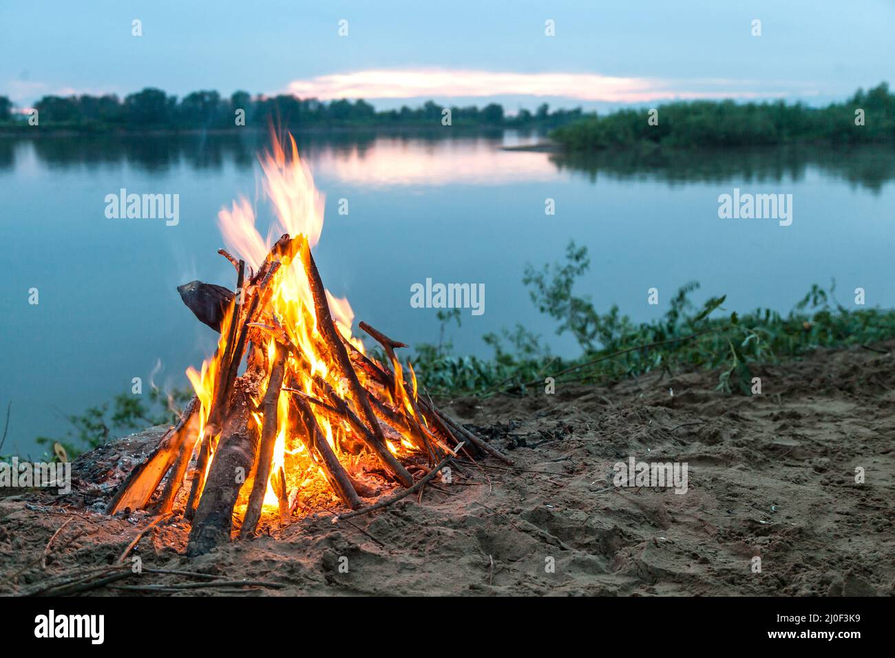 Beautiful bonfire by the river Stock Photo - Alamy