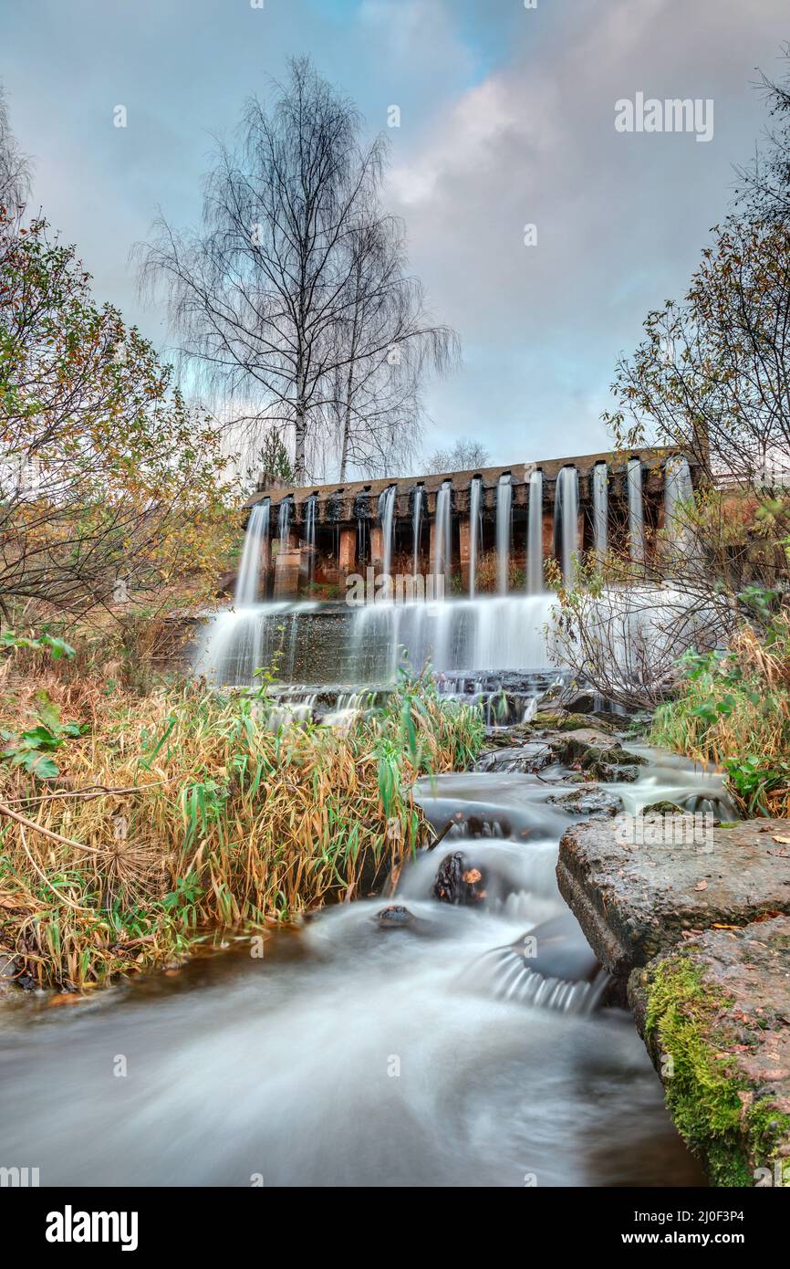 Dam with a waterfall on the river Stock Photo - Alamy
