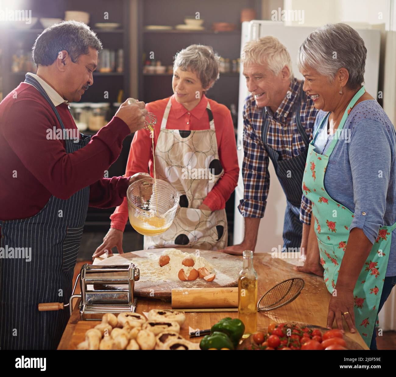 If theres a whisk, theres a way. Shot of a group of seniors cooking in ...