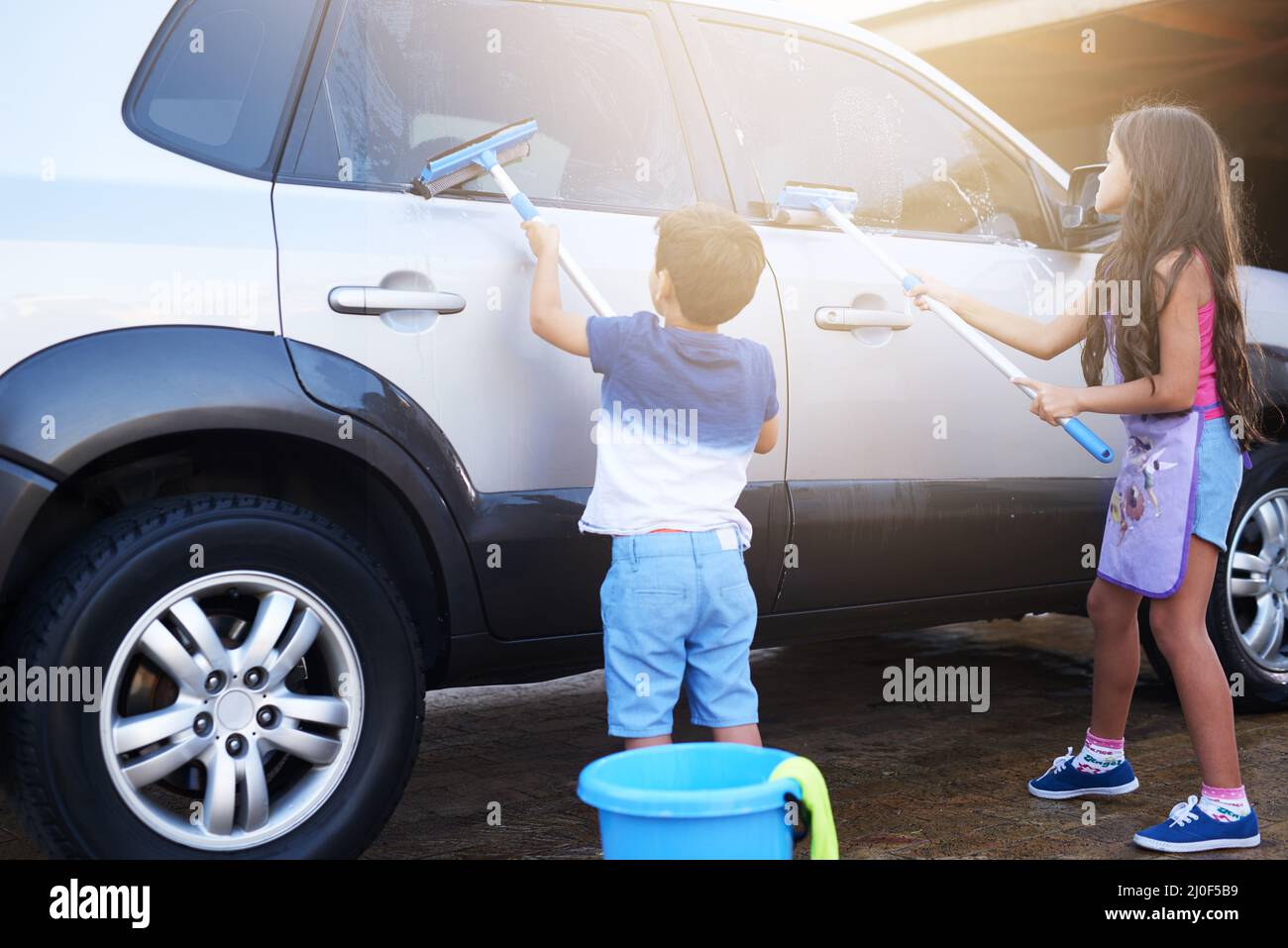Cleaning up is everyones responsibility. Shot of a little boy and his ...