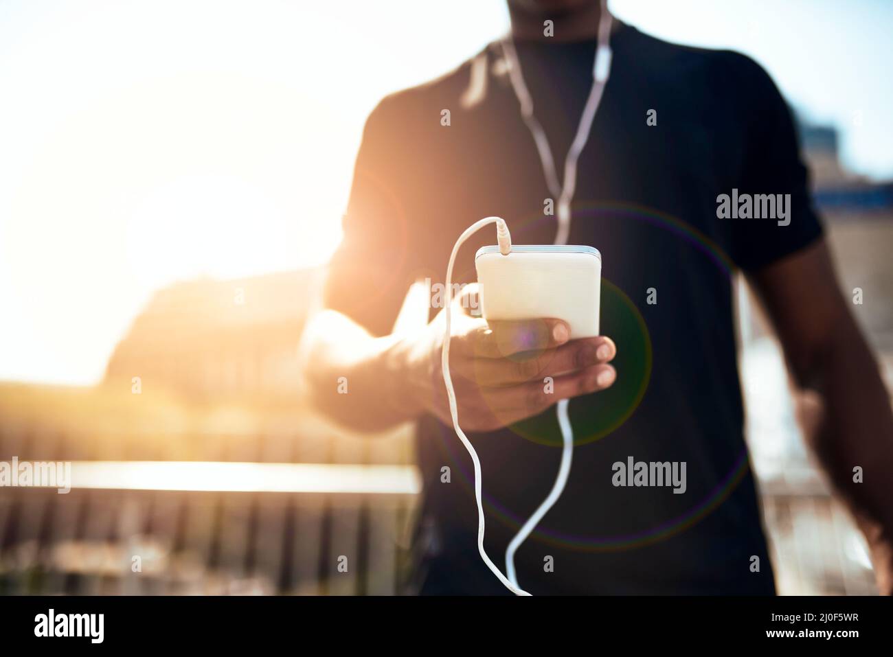 Getting into the zone with some music. Shot of a sporty young man ...