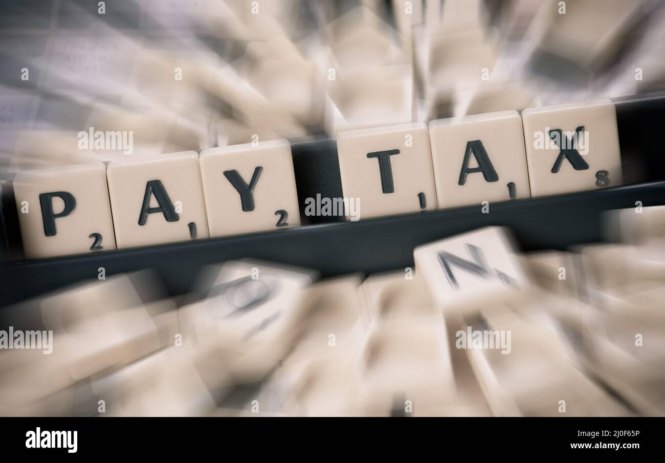 Pay Tax sentence with letters Stock Photo - Alamy