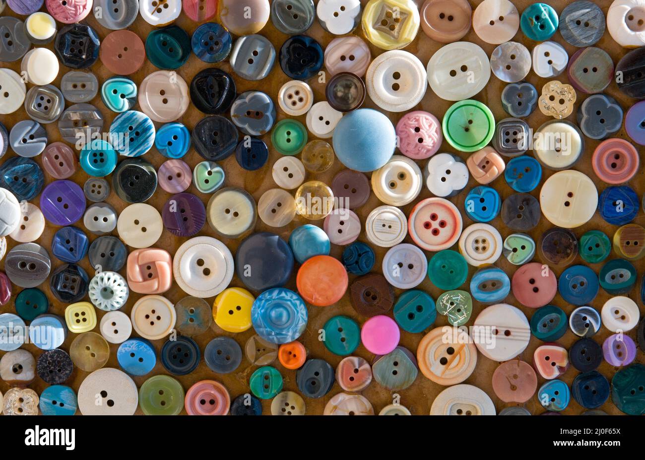 Group of retro colorful fashion buttons on a board Stock Photo - Alamy