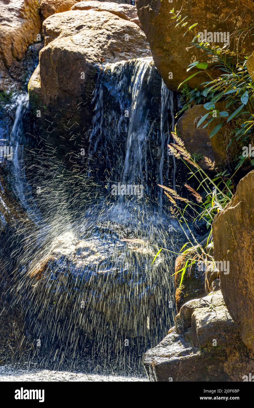 Small waterfall shining between stones Stock Photo - Alamy