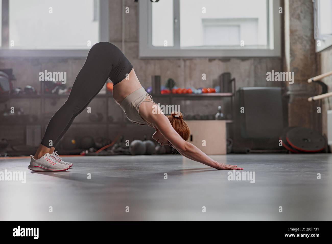 Good looking woman doing yoga pose in gym Stock Photo - Alamy