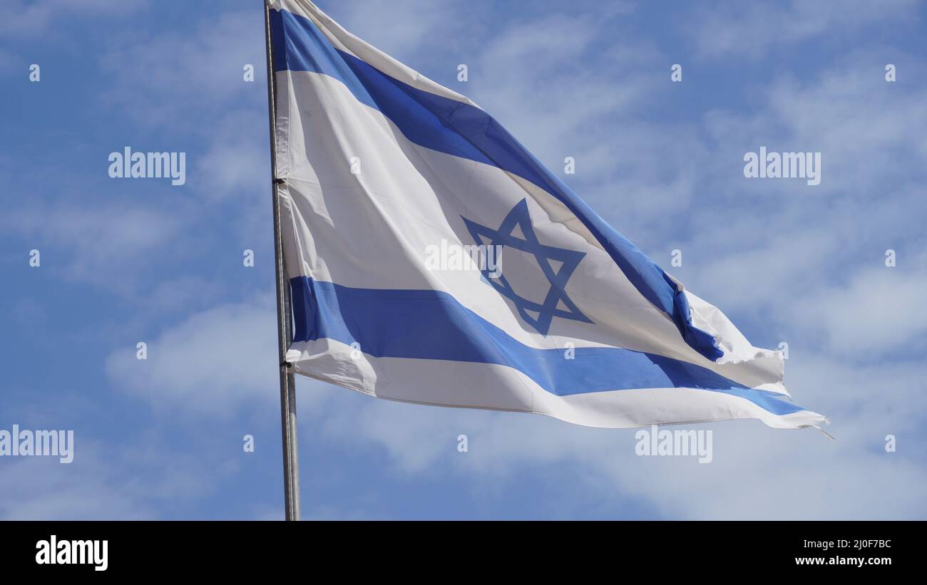 Israeli flag weaving in the wind against bright skies Stock Photo - Alamy