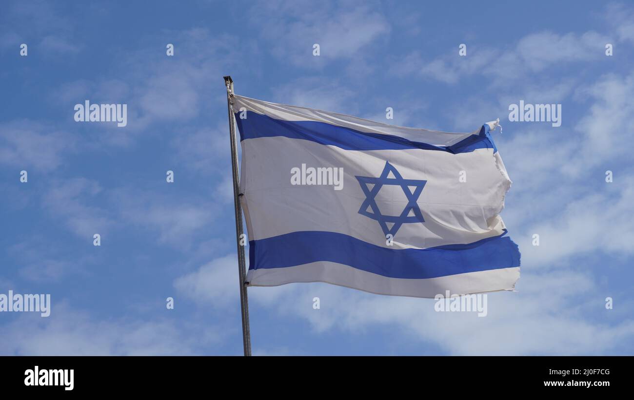 Israeli flag weaving in the wind against bright skies Stock Photo - Alamy