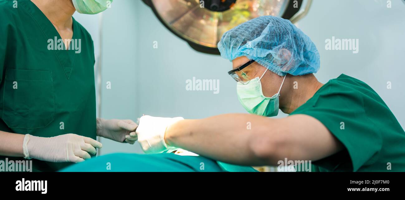 Asian Professional surgeons team performing surgery in the operating ...