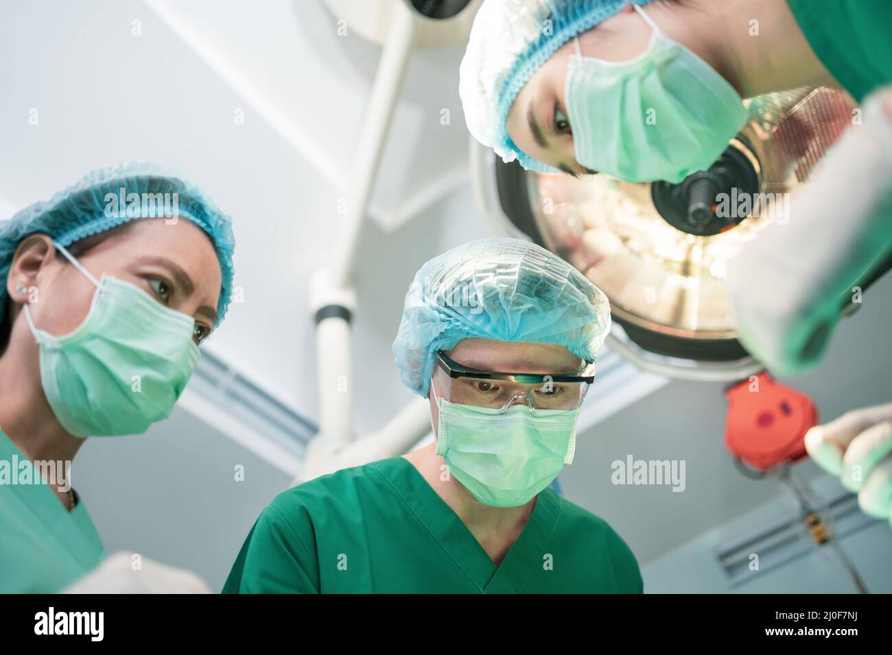 Low Angle Shot of Professional surgeons team performing surgery in ...