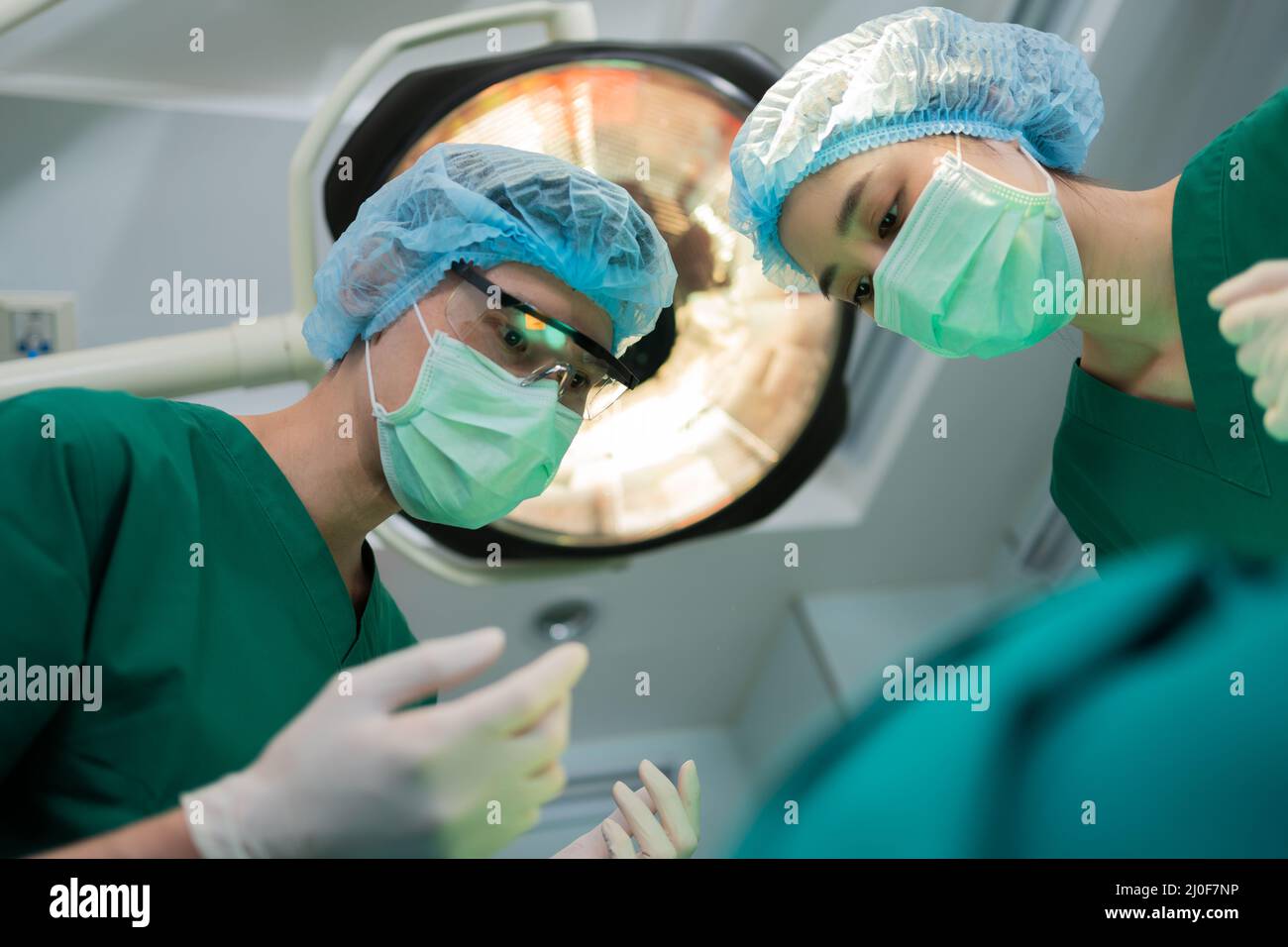 Low Angle Shot of Professional surgeons team performing surgery in ...