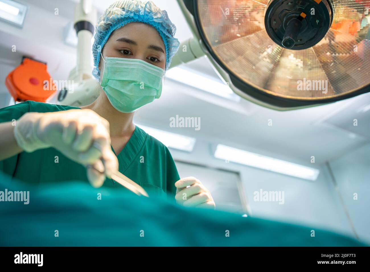 Asian Professional surgeons team performing surgery in the operating ...