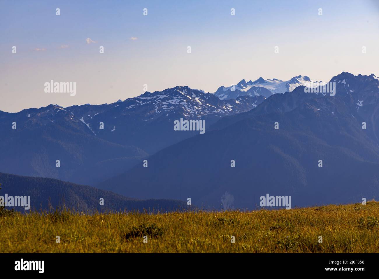 tall mountain range on the other side of a valley Stock Photo - Alamy