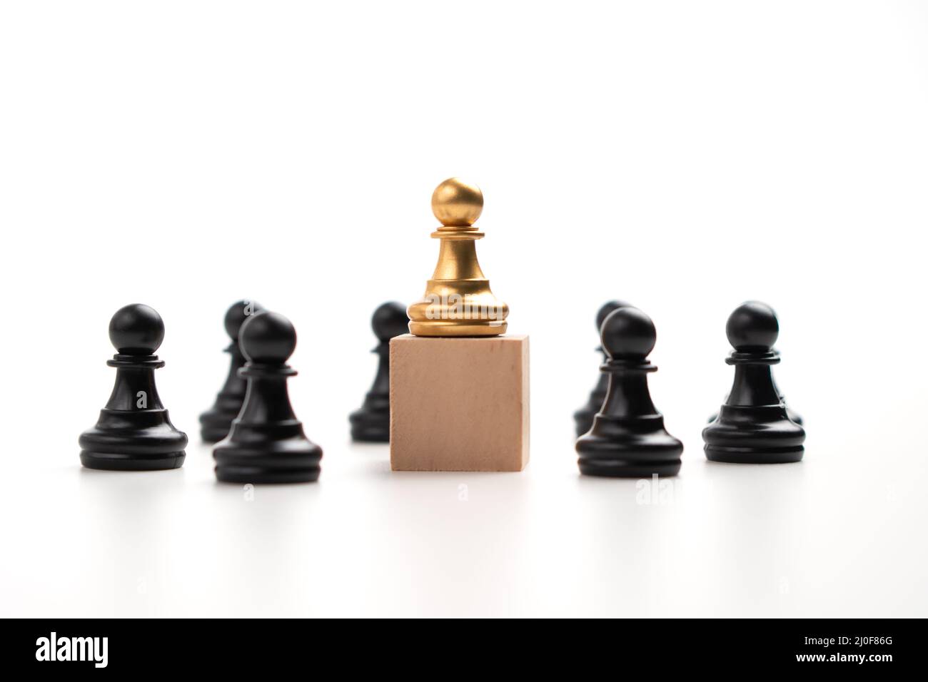 The leadership of the Golden chess pawn standing on the box show ...