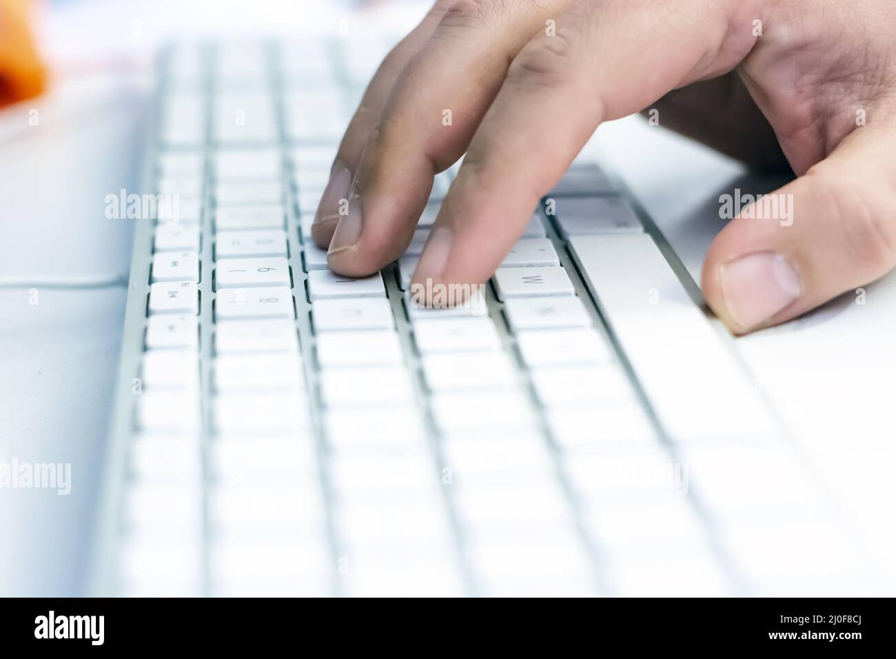 A male hand over the white keyboard of a computer before typing Stock ...