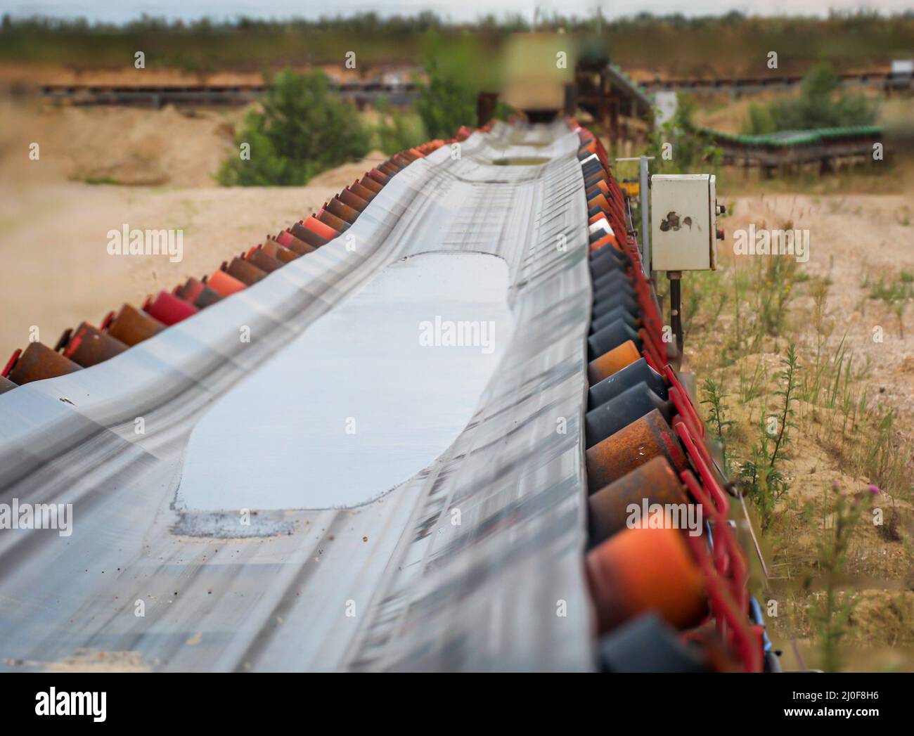 View over a conveyor belt for the transport of gravel in a gravel pit ...