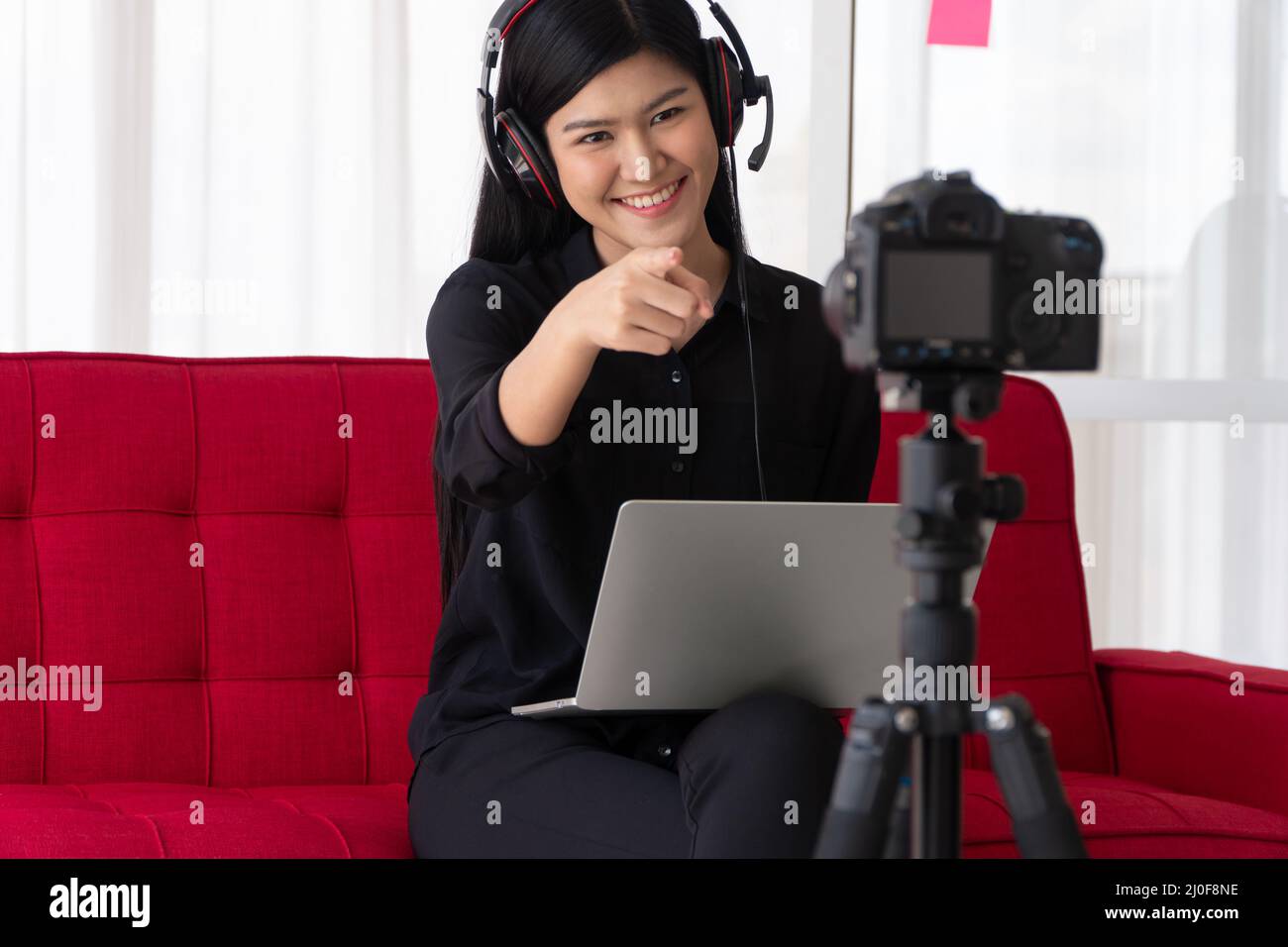 Vlog Asian woman blogger influencer sitting on the sofa in home and ...