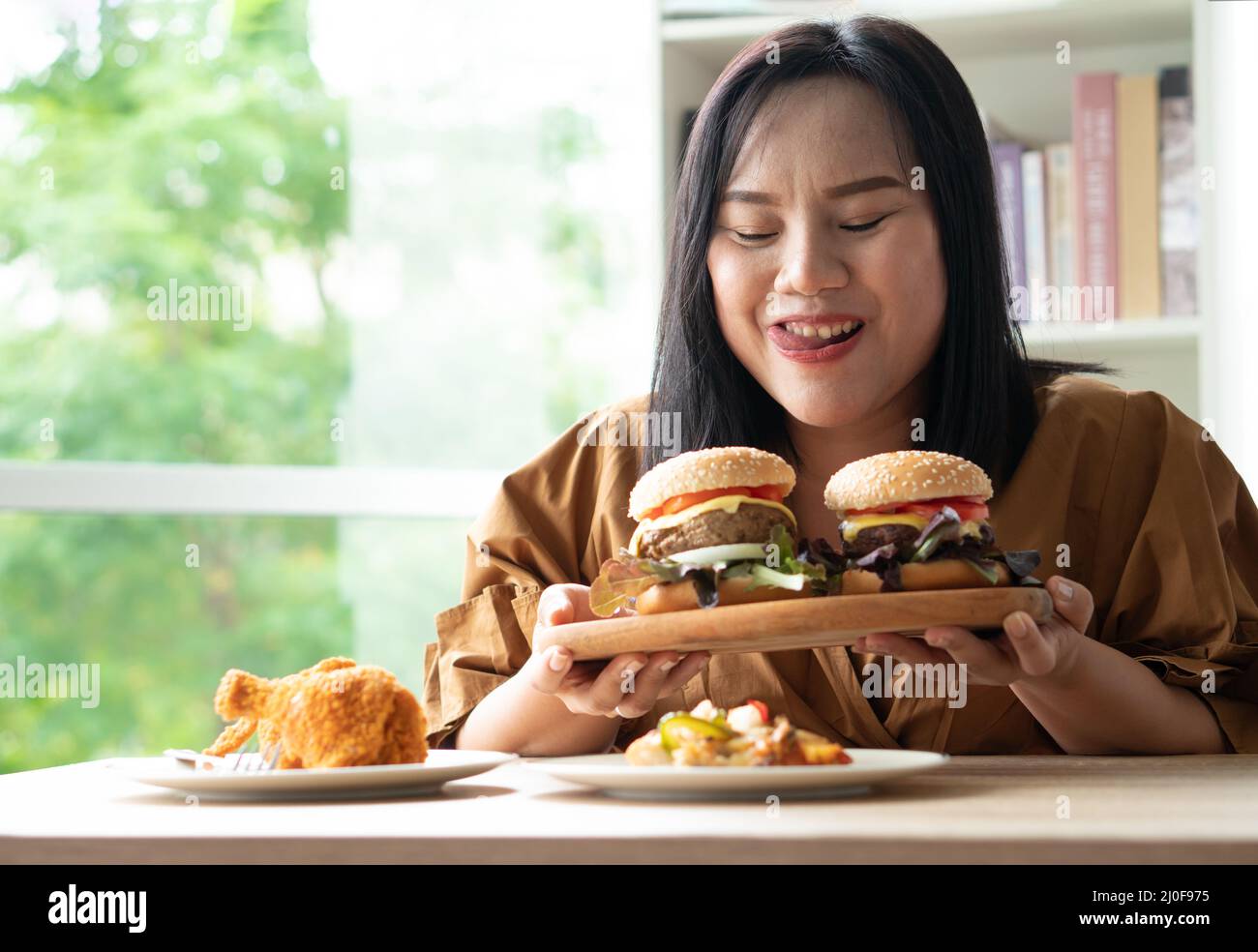 Obese woman eating fast food chicken hi-res stock photography and ...