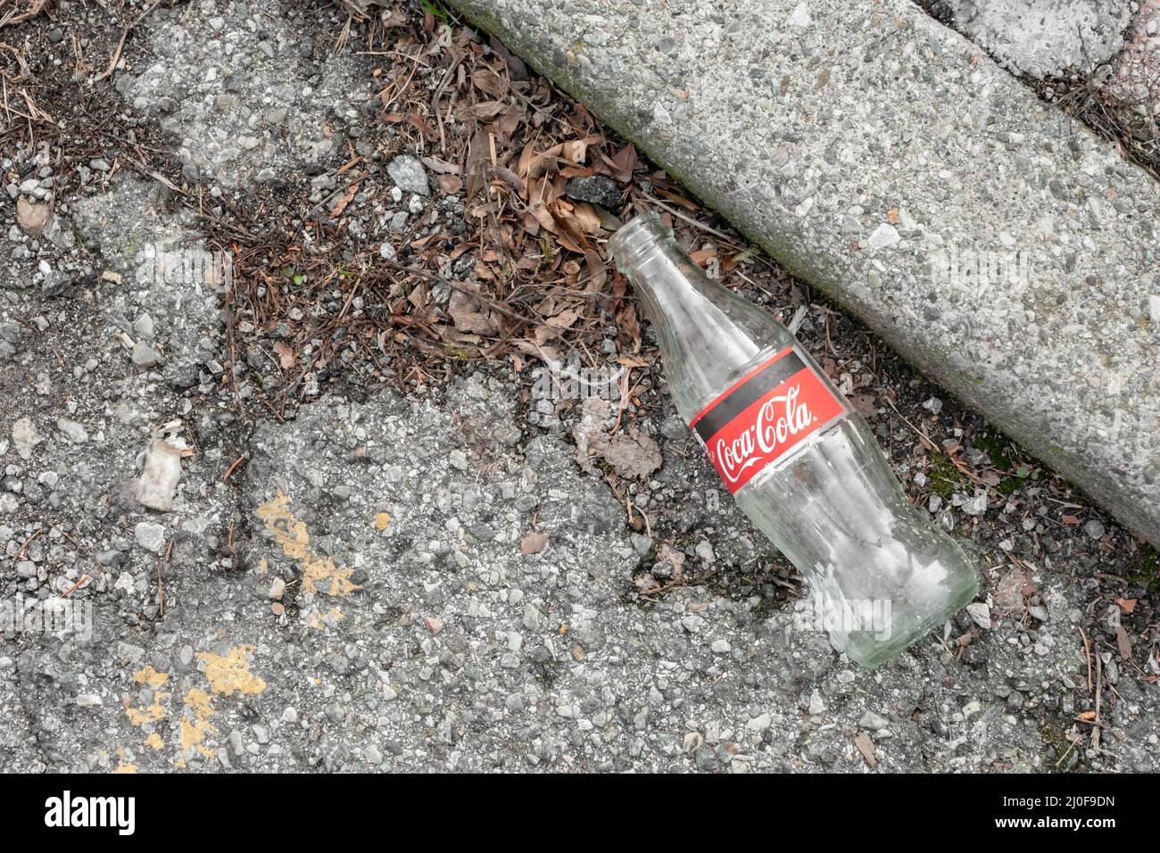Glass bottle thrown on the ground Stock Photo - Alamy