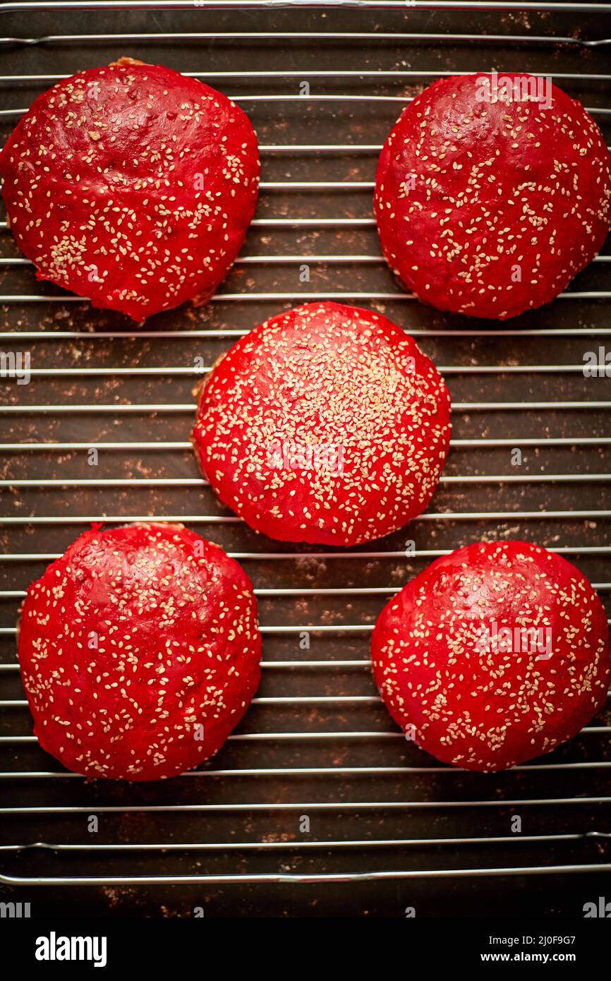Fresh baked red homemade burger buns with sesame top view. Placed on ...