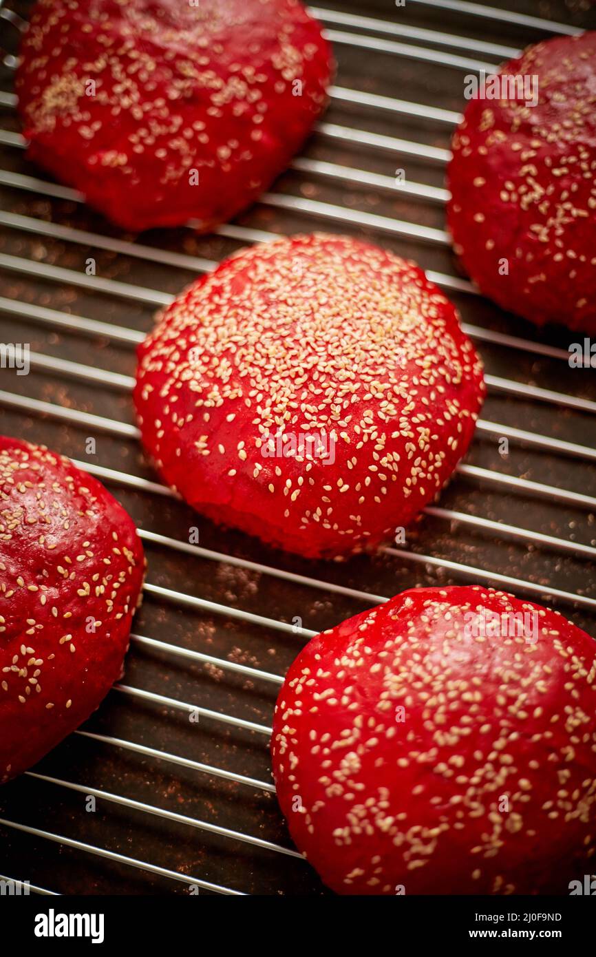 Fresh baked red homemade burger buns with sesame top view. Placed on ...