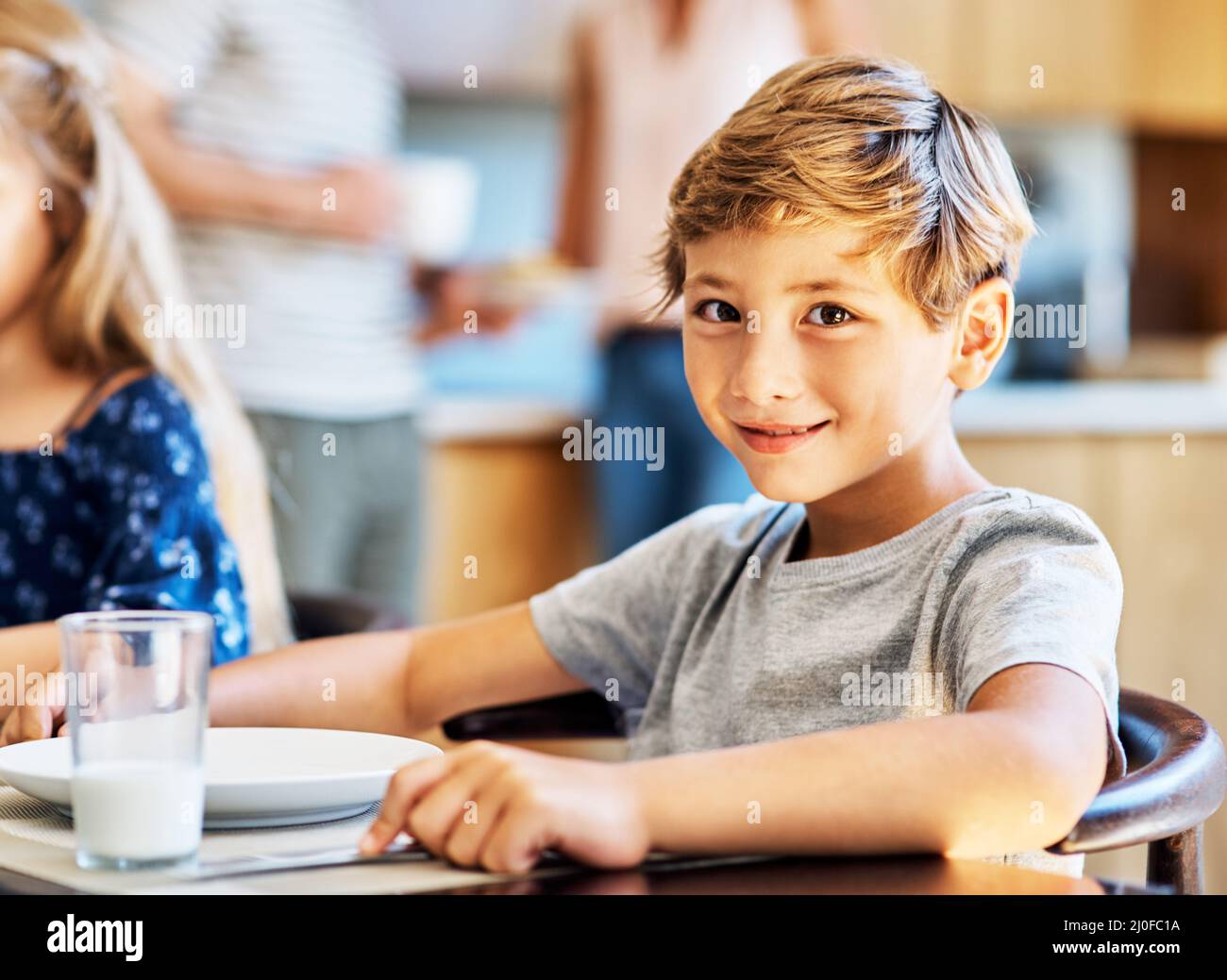 Breakfast is especially important for growing kids. Portrait of a young ...