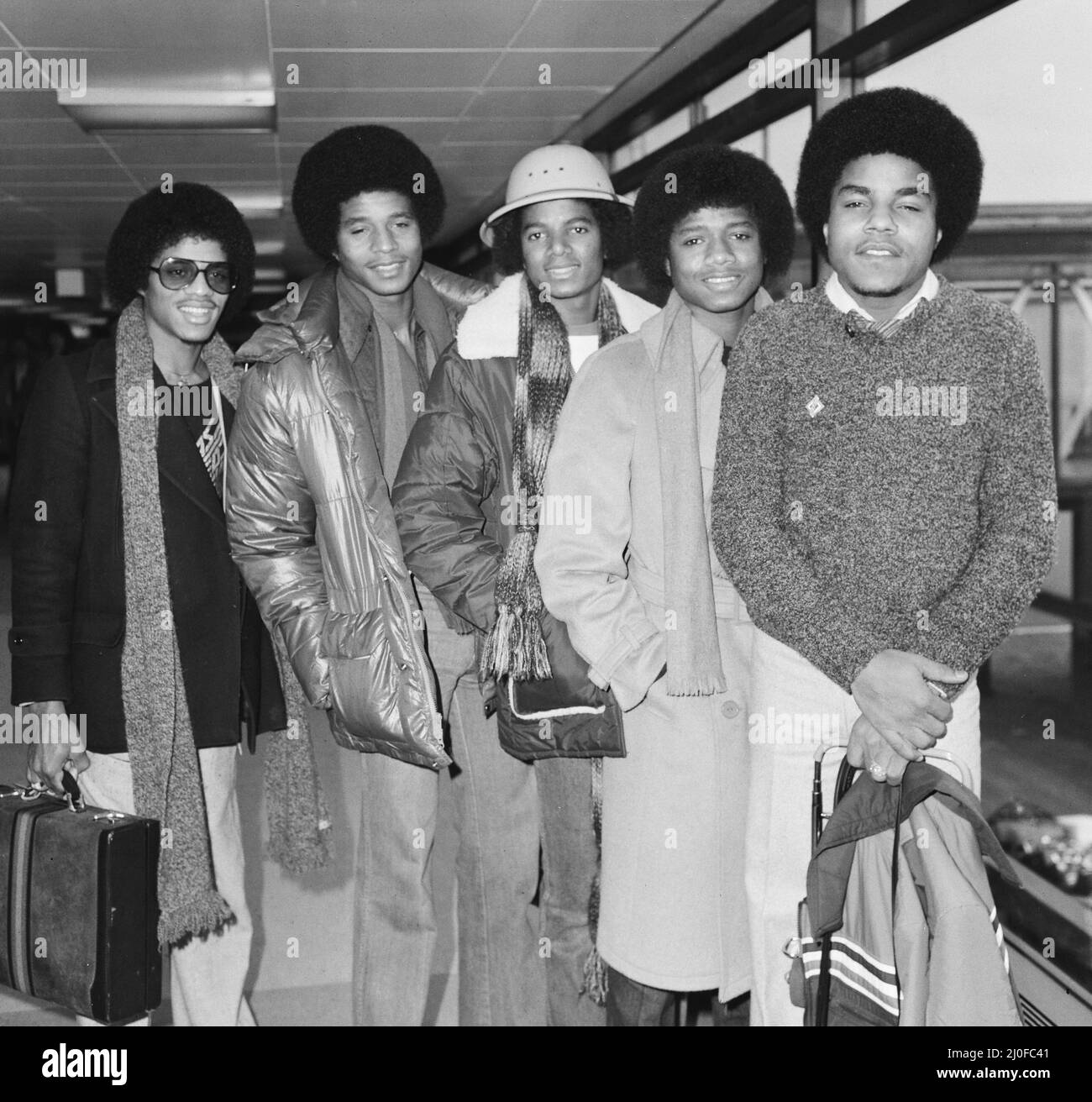 Members of The Jackson Five pop group make their way through the ...