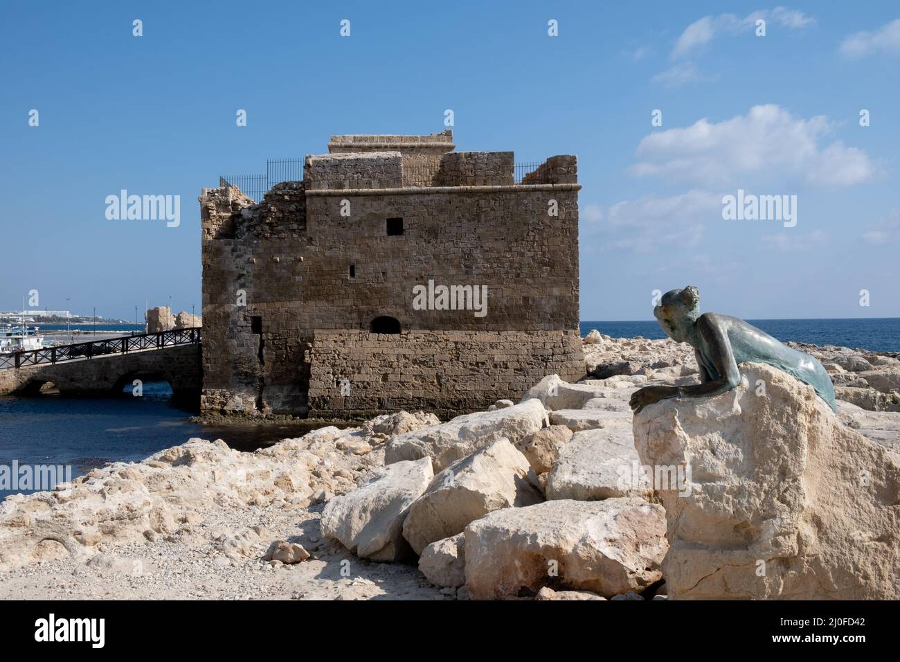 Bronze statue of woman on a stone looking at the castle. Paphos Cyprus ...