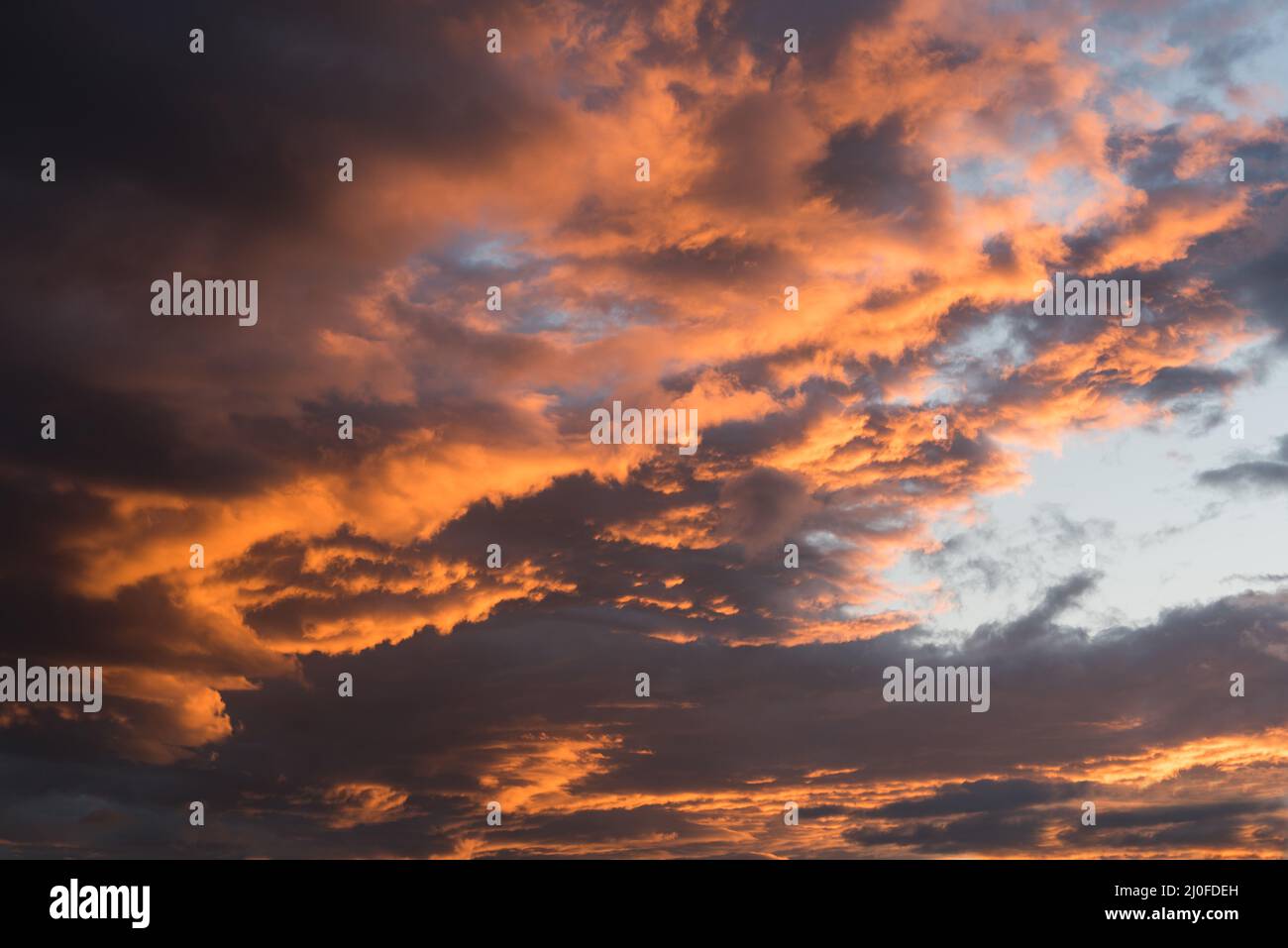 Dramatic sunset sky with orange cloud colors Stock Photo - Alamy