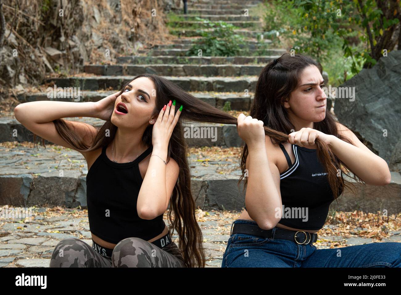 Two women fighting and pulling each others hair Stock Photo - Alamy