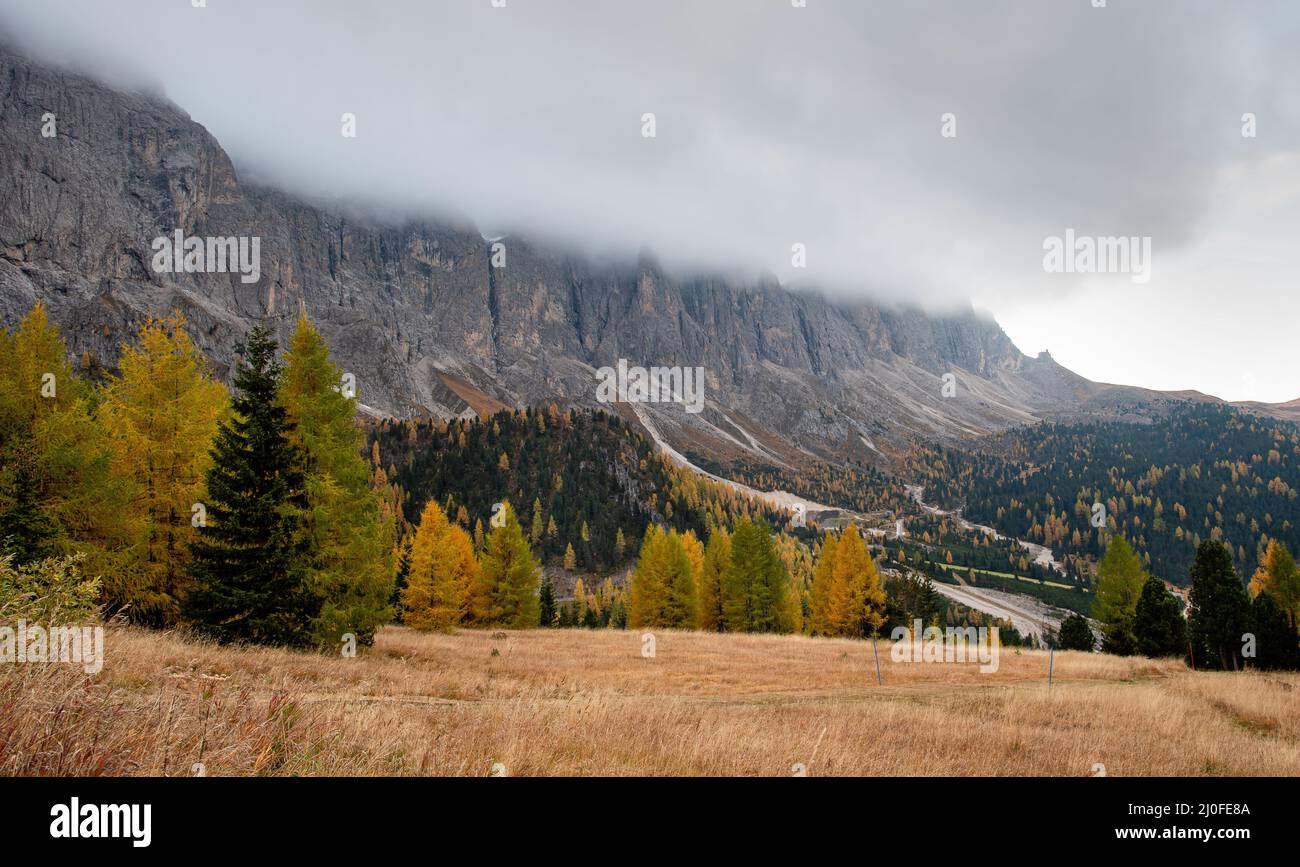 Dolomite mountain peaks covered in fog during sunrise Stock Photo - Alamy
