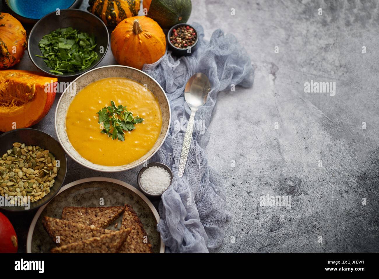 Pumpkin soup decorated with parsley for Thanksgiving, halloween. Placed ...