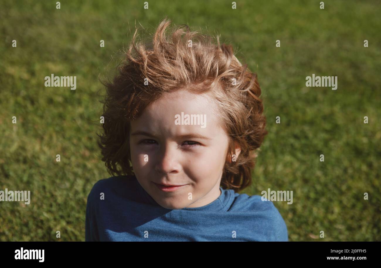 Funny child face close up. Kids on grass in park head portrait Stock ...