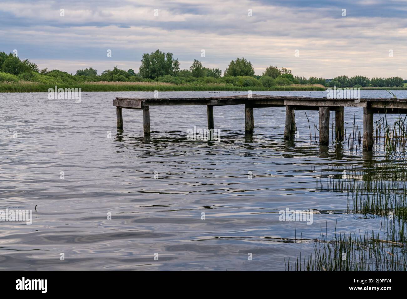 A wooden jetty leading into the Zahrener See (Lake Zahren) near Gallin ...