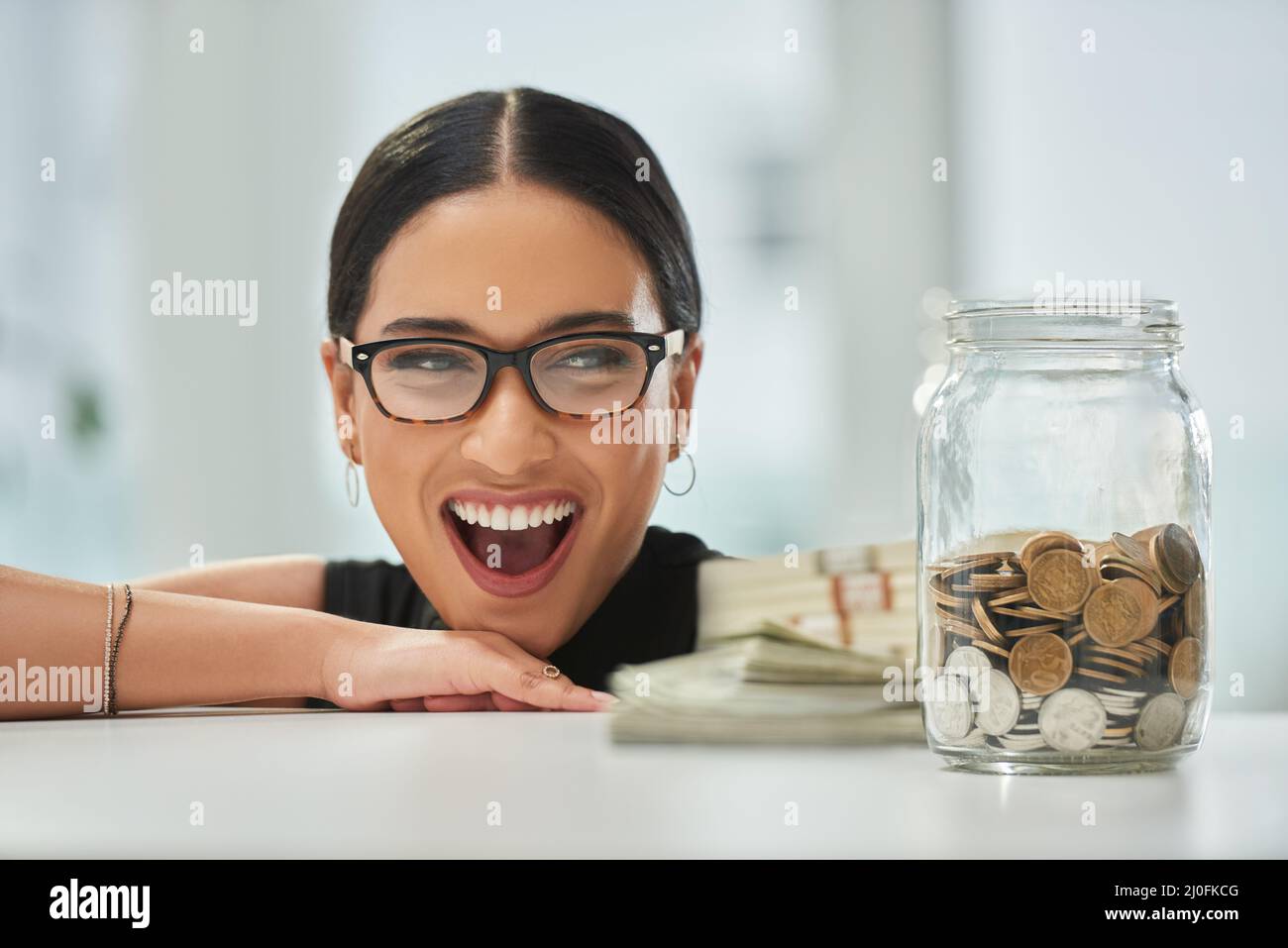 Her savings will surely surprise. Cropped shot of an attractive young ...