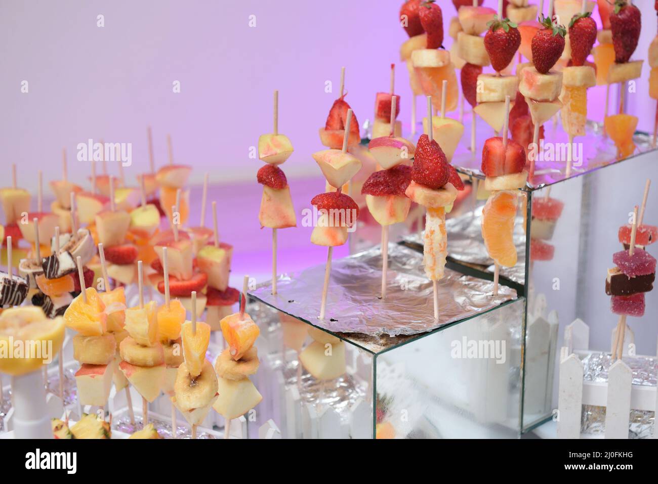 Wedding buffet table with different sliced snacks, fruits, and berries ...