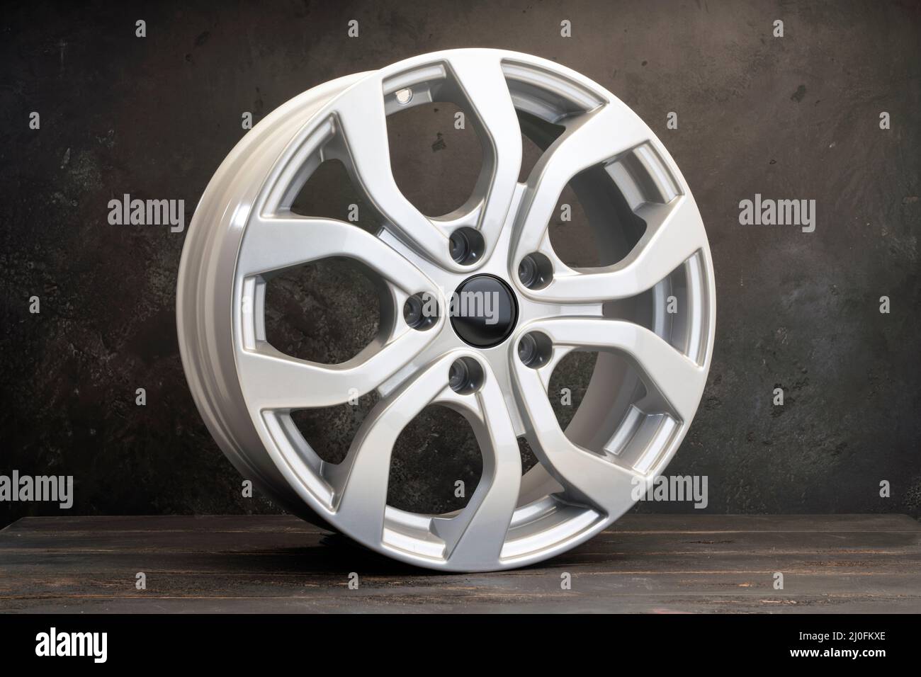 new grey alloy wheels on a dark textured black background. a wheel for ...